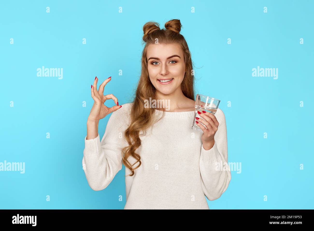 woman with drinking glass of water showing Ok gesture Stock Photo - Alamy