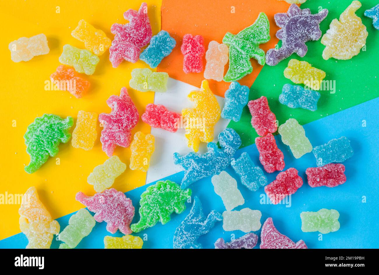 Dinosaurs and bear colorful jelly bonn, candies on the color background ...