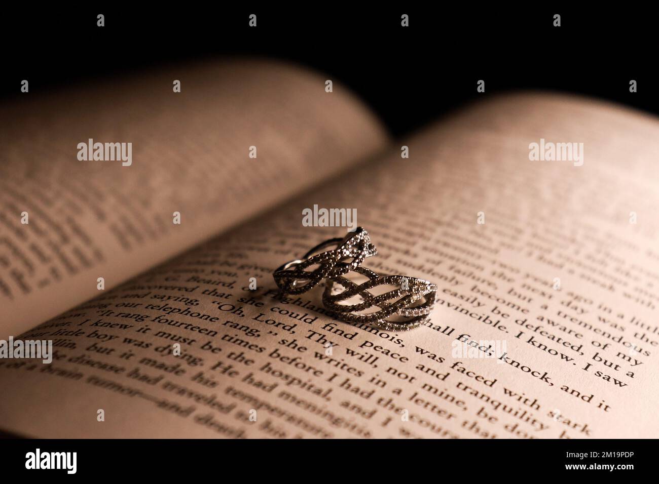 Rings sitting on a book Stock Photo - Alamy