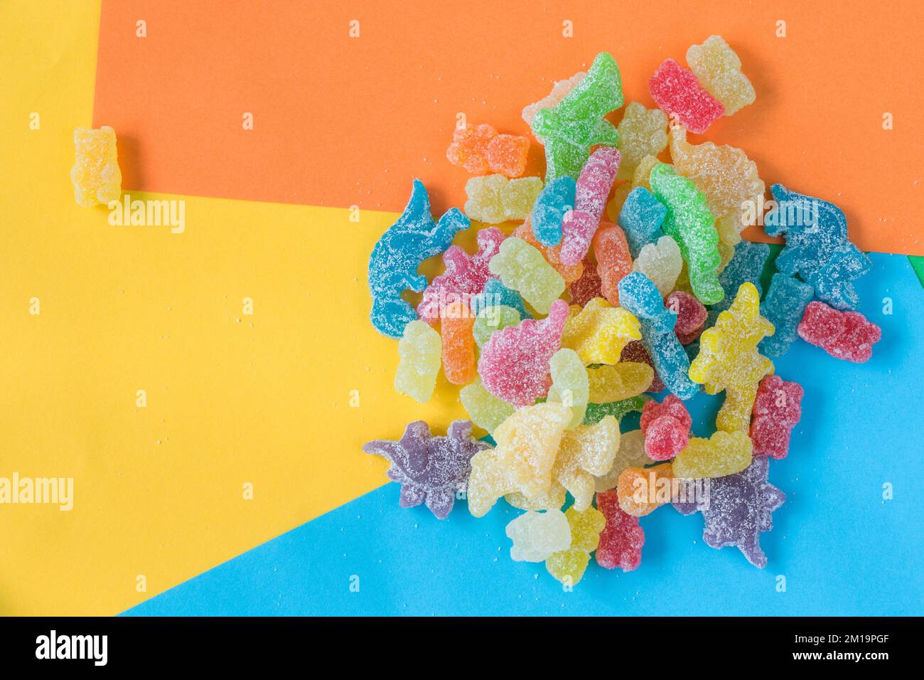 Dinosaurs and bear colorful jelly bonn, candies on the color background ...