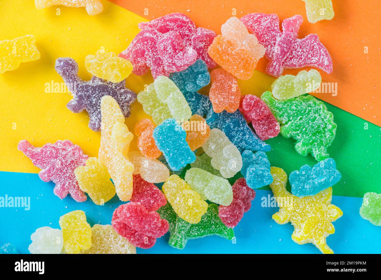 Dinosaurs and bear colorful jelly bonn, candies on the color background ...