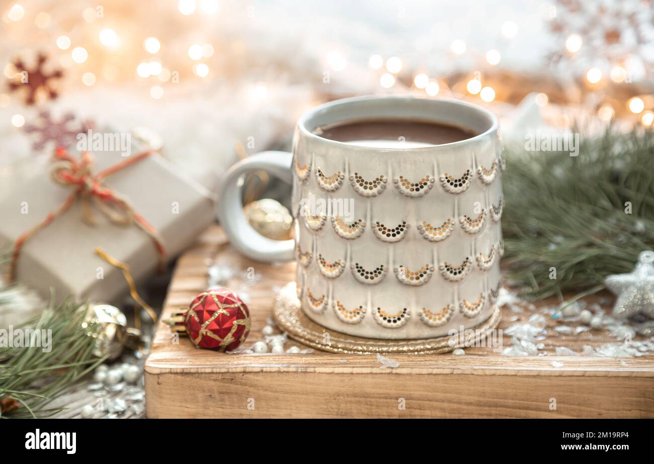 Christmas composition with a cup of coffee on a blurred background ...