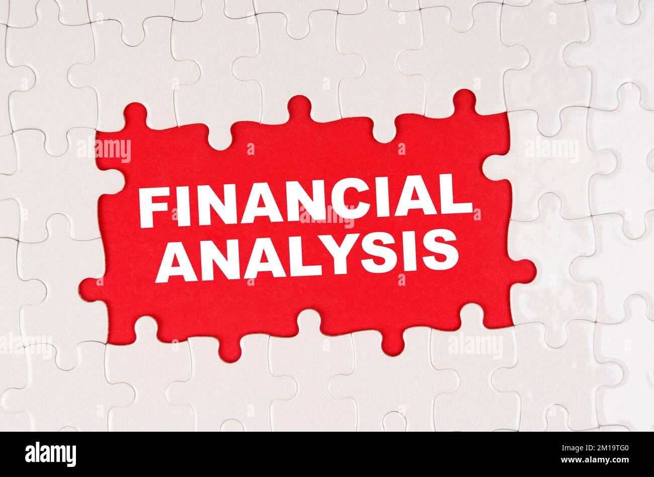Business and finance concept. In the middle of the puzzles on a red ...