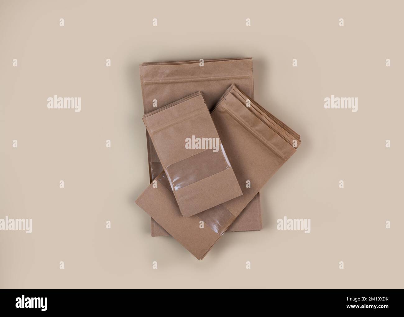 Brown kraft paper doypack bags with groceries front view on a yellow ...