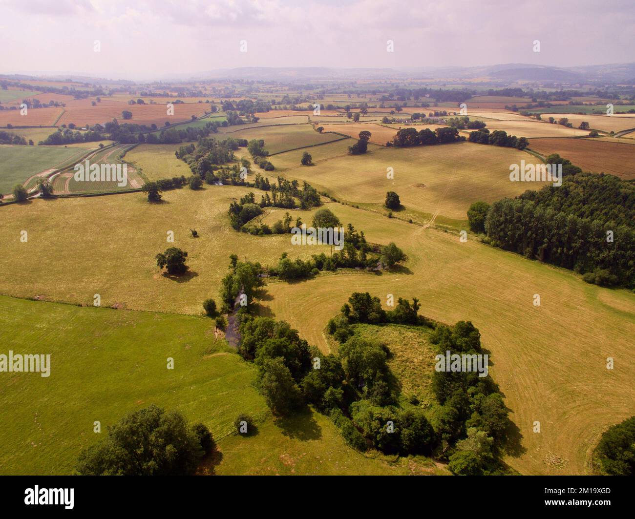 An aerial view of river Clun in green agricultural fields on a sunny ...