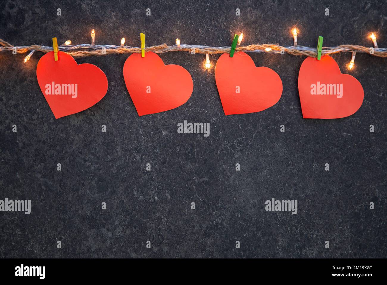 Red cardboard hearts pinned with clothespins on a rope, flat lay Stock ...