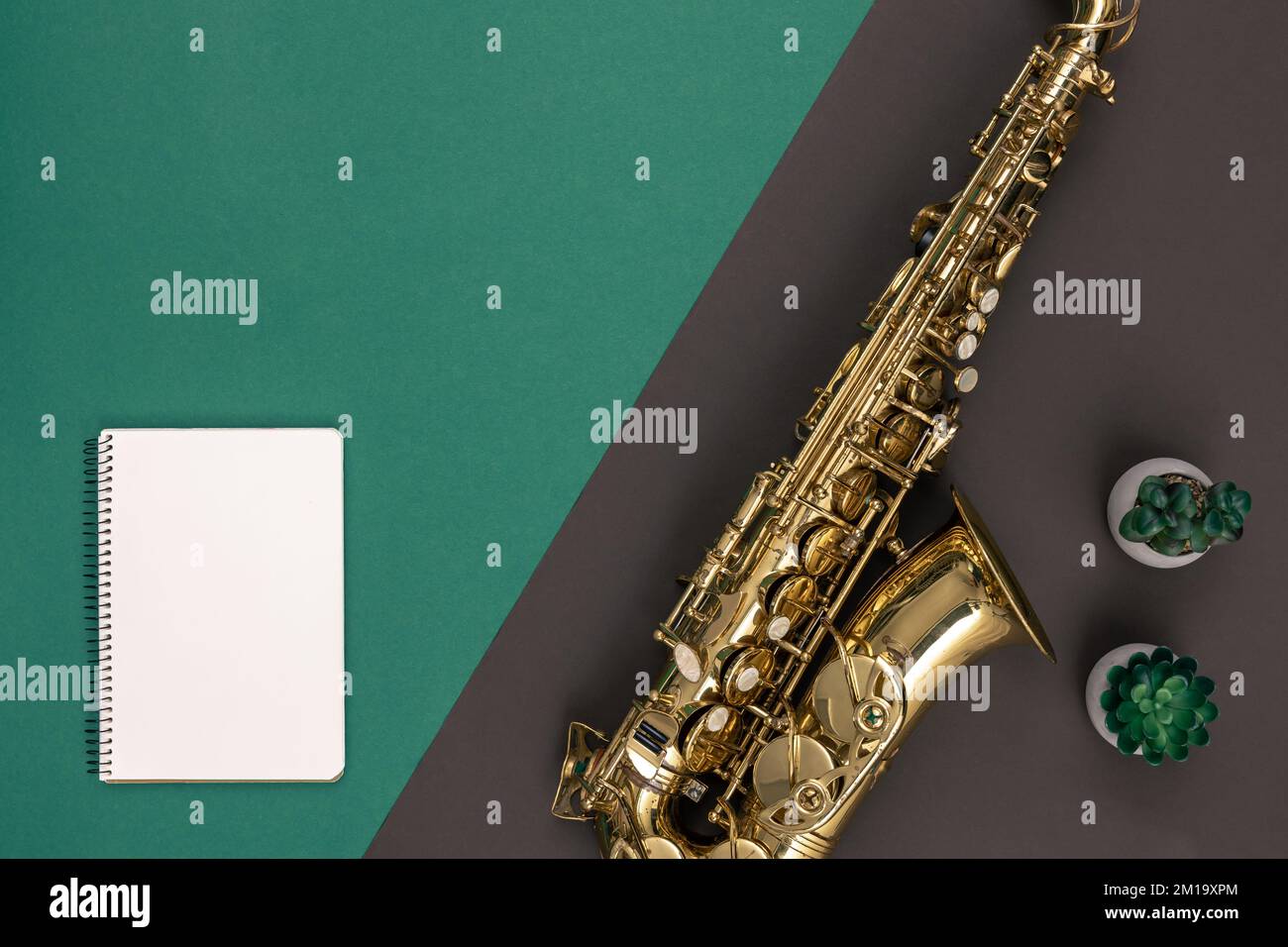 Saxophone on a green background and notepad, top view Stock Photo - Alamy