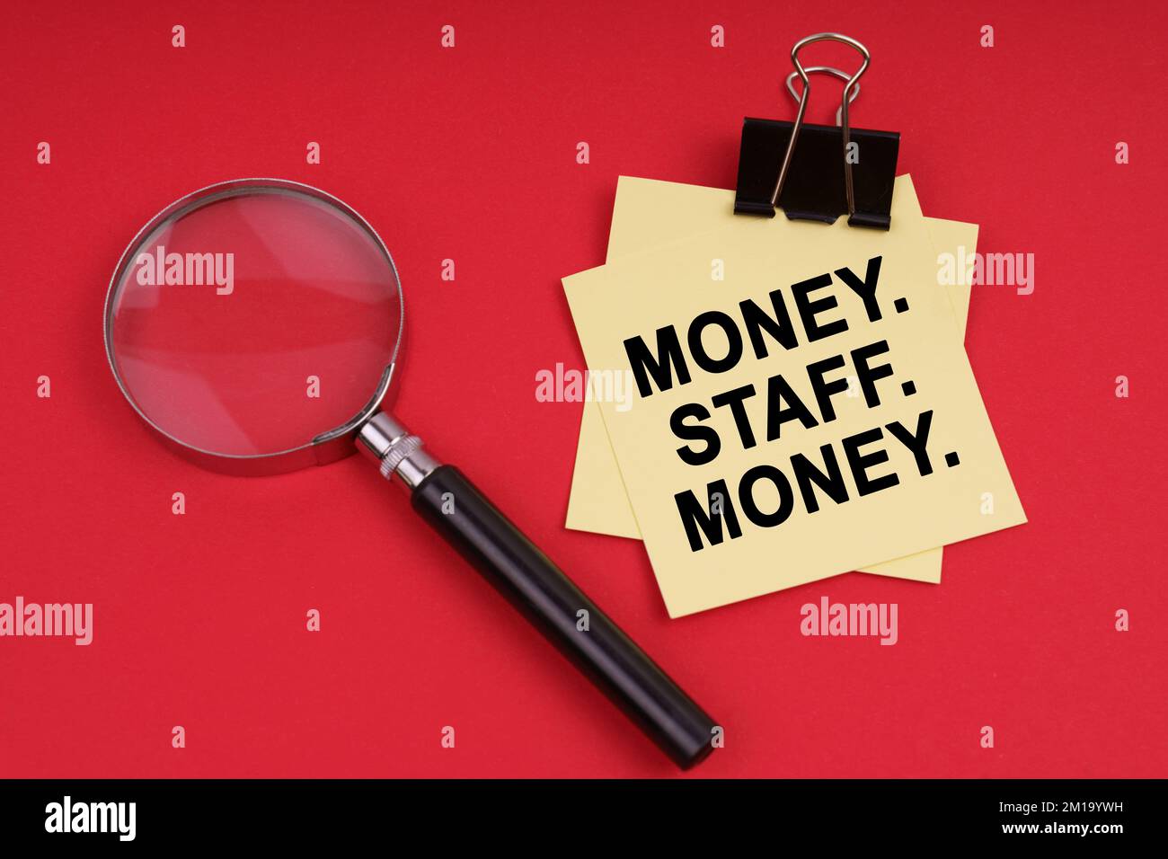 Business and Economics. On a red background, a magnifying glass and a ...