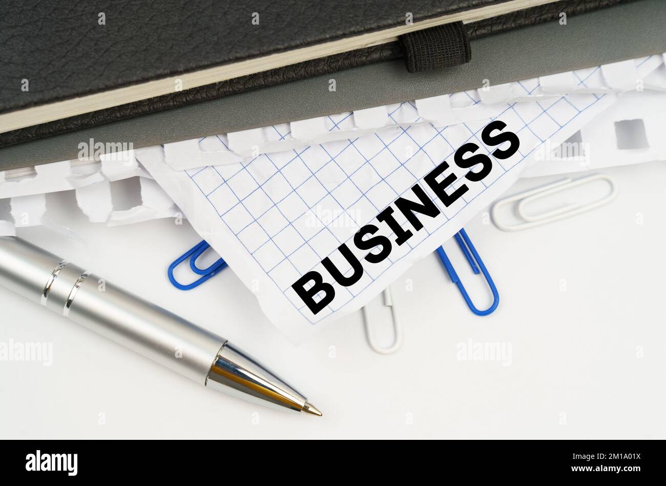 Business concept. On the table is a pen, notebooks and a crumpled sheet ...