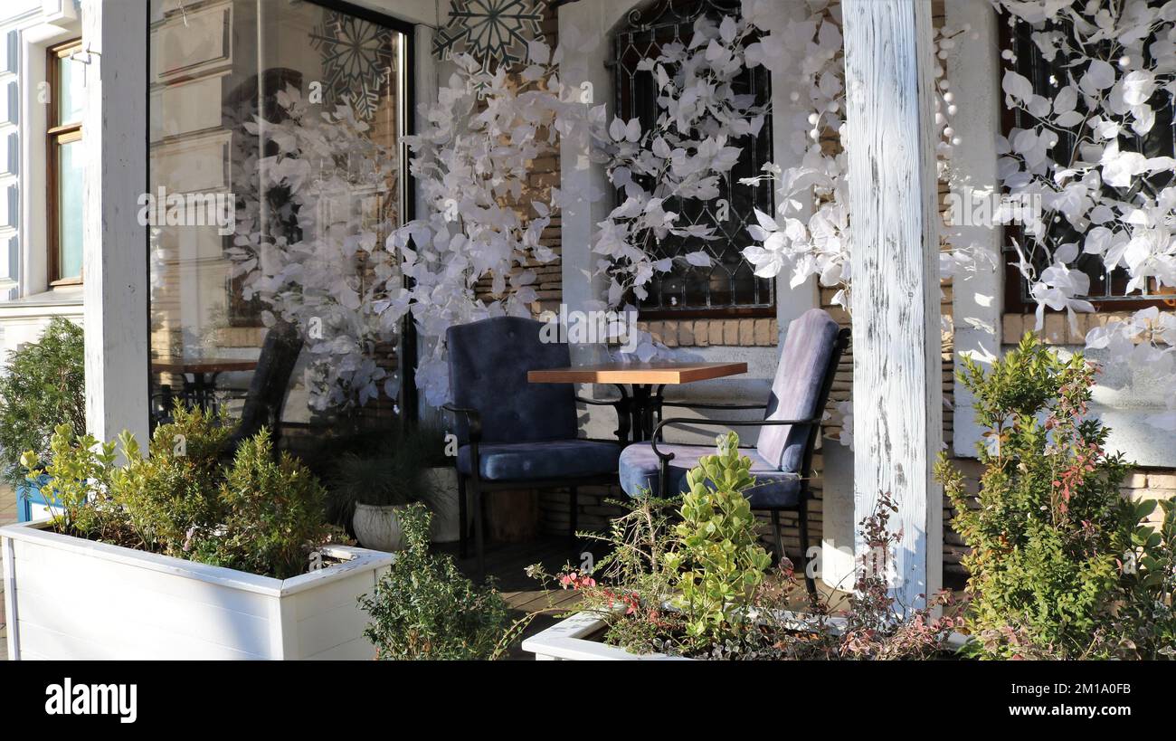 a cozy corner of an urban street cafe on the terrace with a table for ...