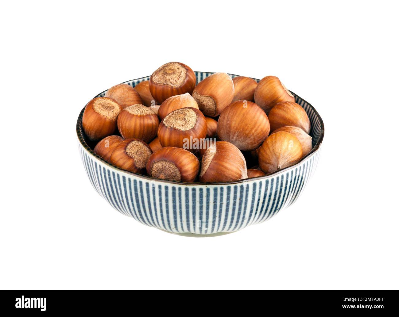 Bowl full of hazelnuts isolated, front view close up Stock Photo - Alamy