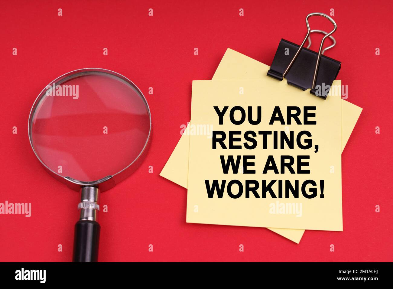 Business and Economics. On a red background, a magnifying glass and a ...