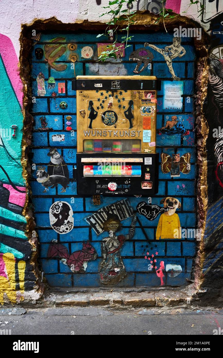 A vertical shot of the art vending machine against a blue wall with ...