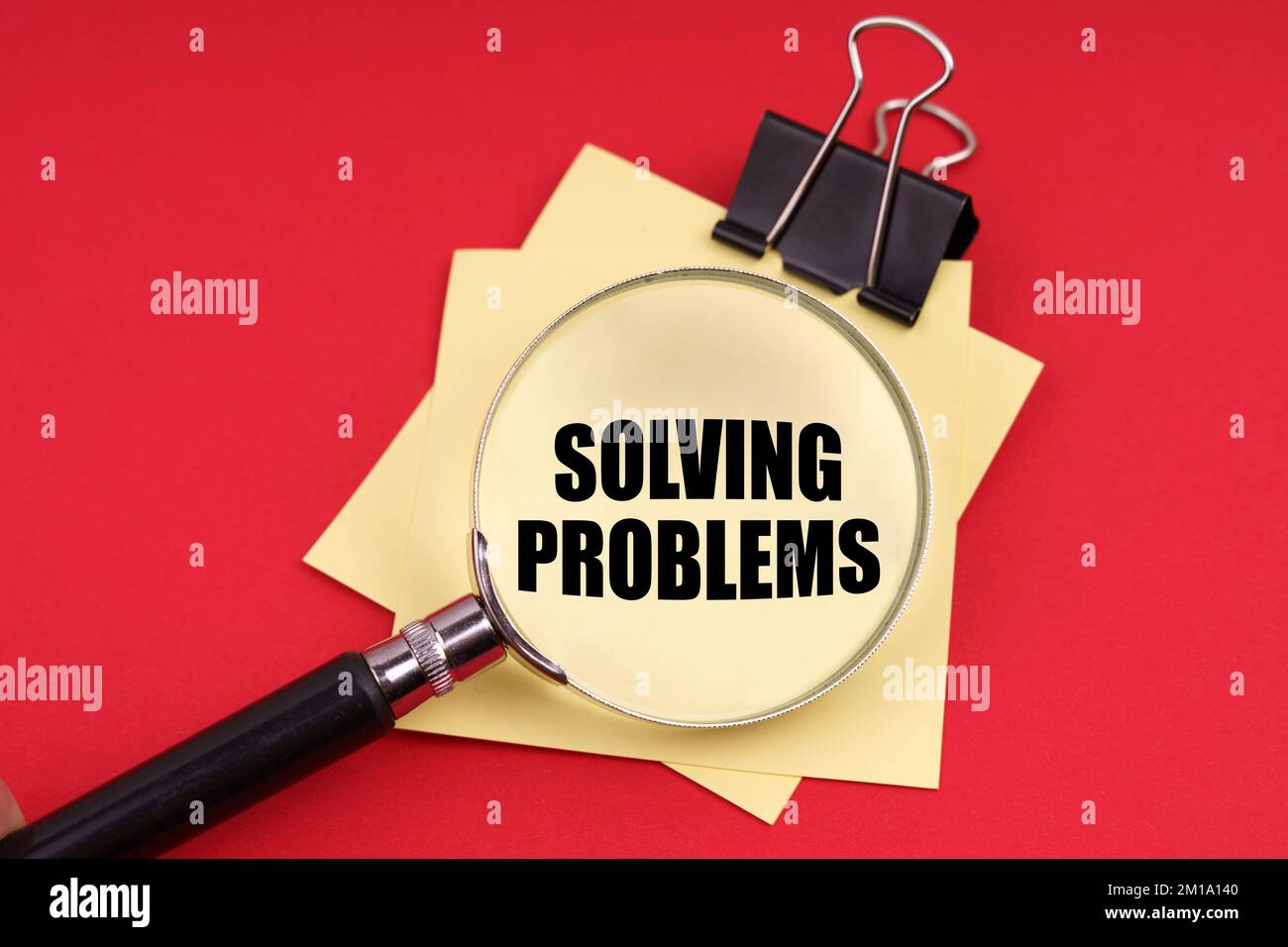 Business and Economics. On a red background, a magnifying glass and a ...