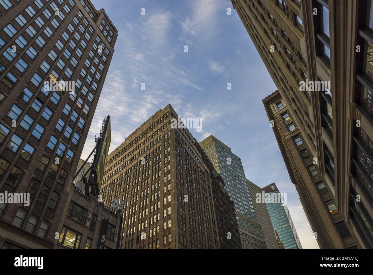 Beautiful bottom-up view of Manhattan's skyscrapers on blue sky ...