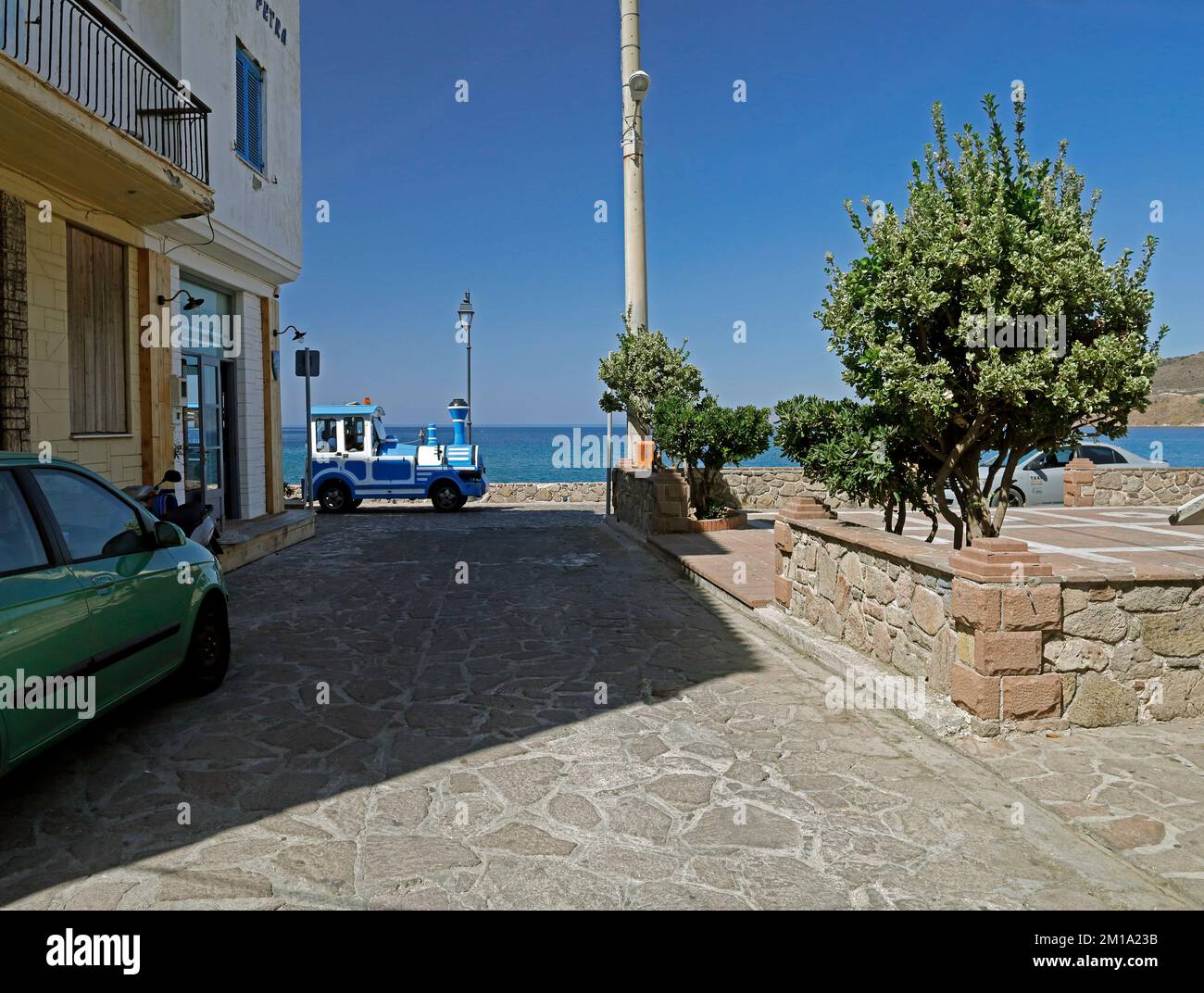 Land train passes end of street in Petra town along the seafront on the ...