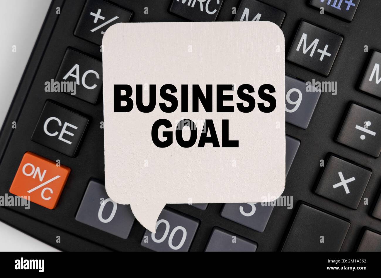 Business and economy concept. There is a white plate on the calculator ...