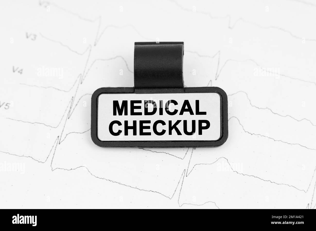 Medicine and health concept. There is a plate on the cardiogram with ...