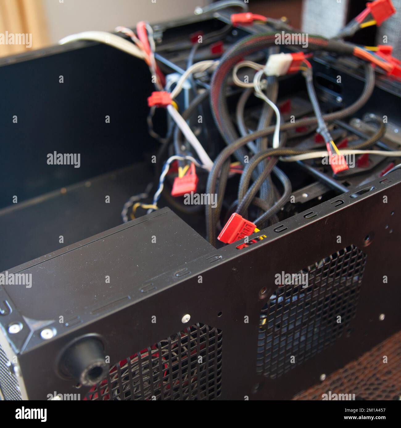 Desktop computer, black empty case and various cables, which are tried ...