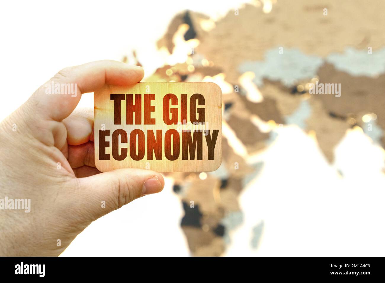 Business concept. Against the background of the world map, a man holds ...