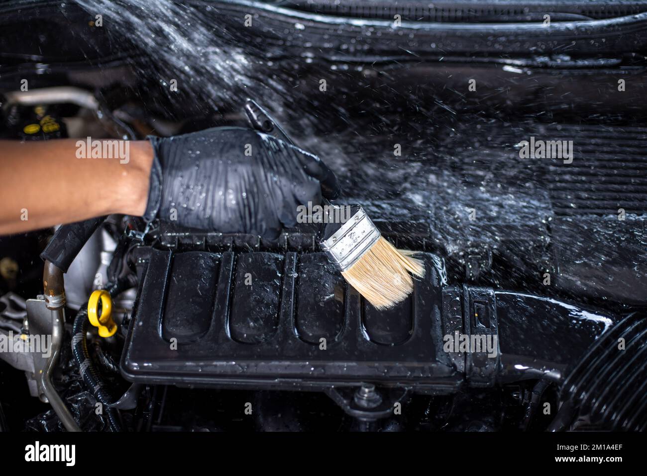 Cleaning the engine bay. Car cleaning and car detailing concept Stock ...