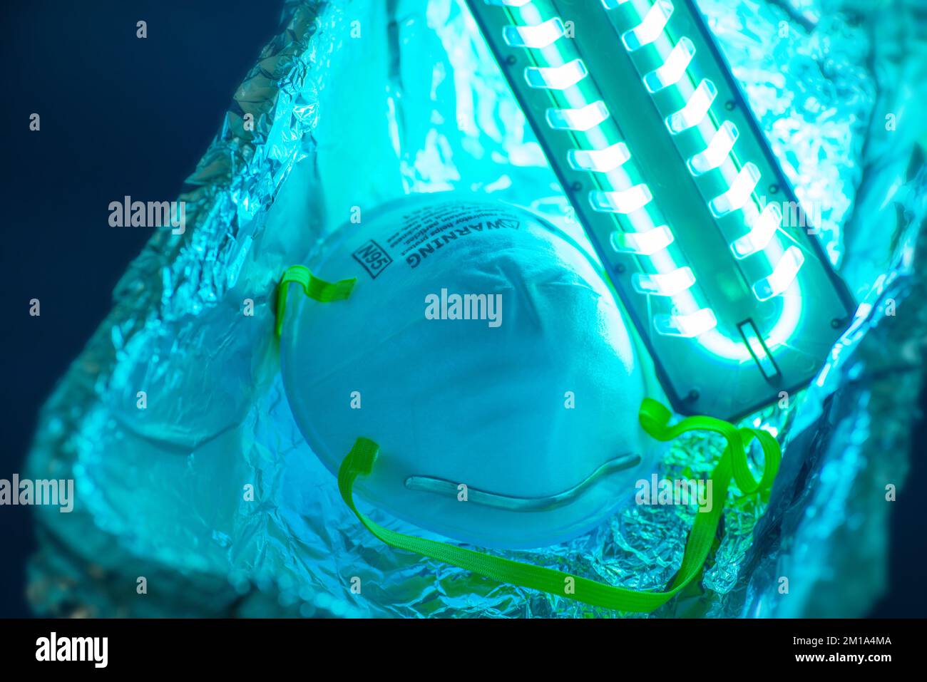 UV light sterilization of face mask to disinfect and reuse. COVID-19 ...