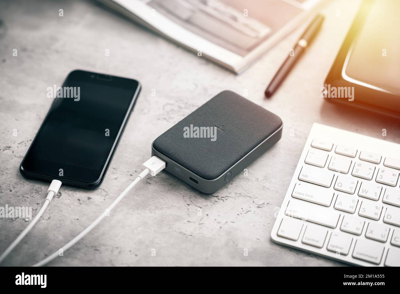 Smartphone battery charging with power bank. close-up at the grey power ...