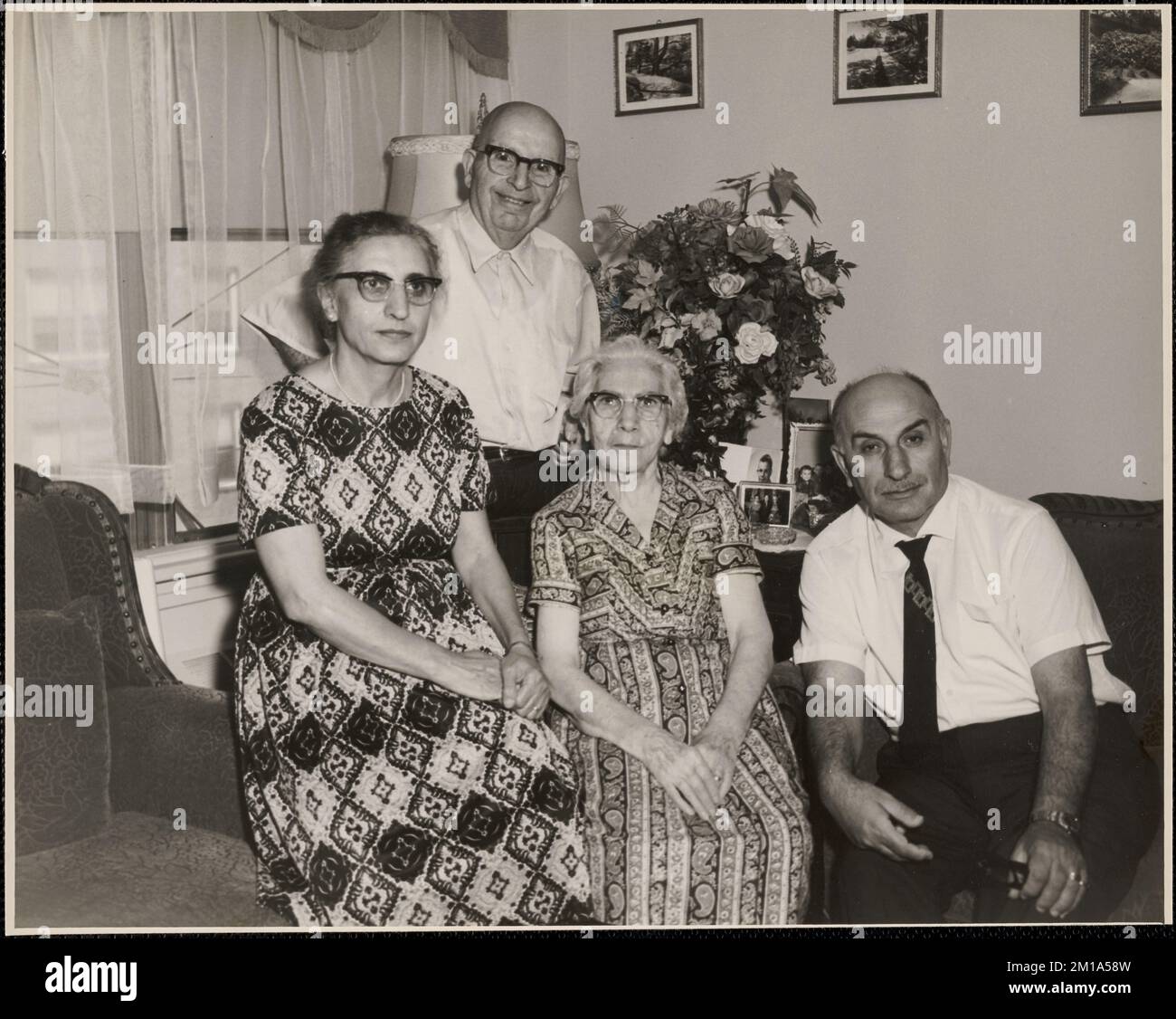 Two women and two men of Changelian family seated in front of flowers ...