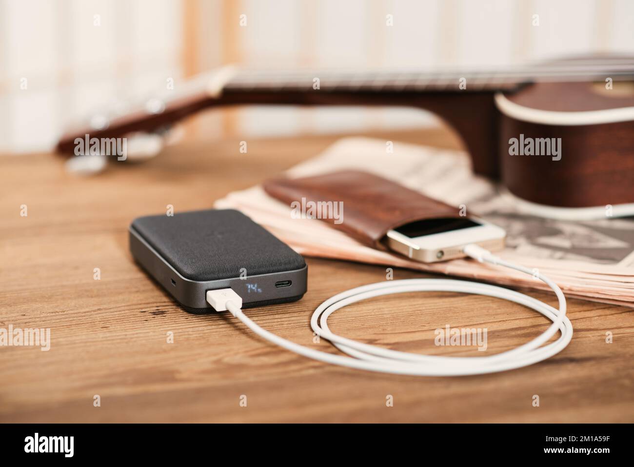 Smartphone battery charging with power bank. close-up at the grey power ...