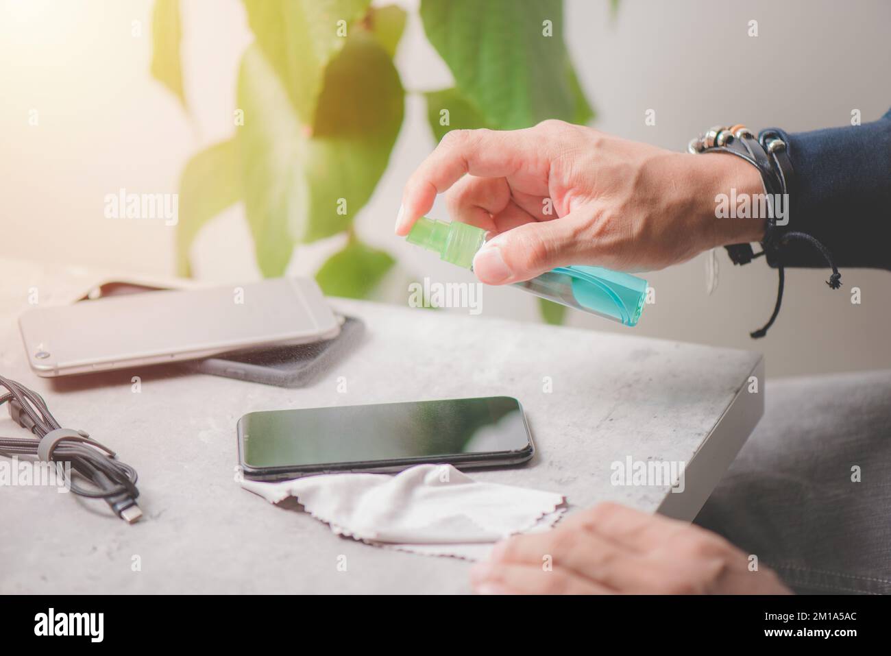 Cleaning the smartphone with soft cloth and alcohol. COVID-19 ...