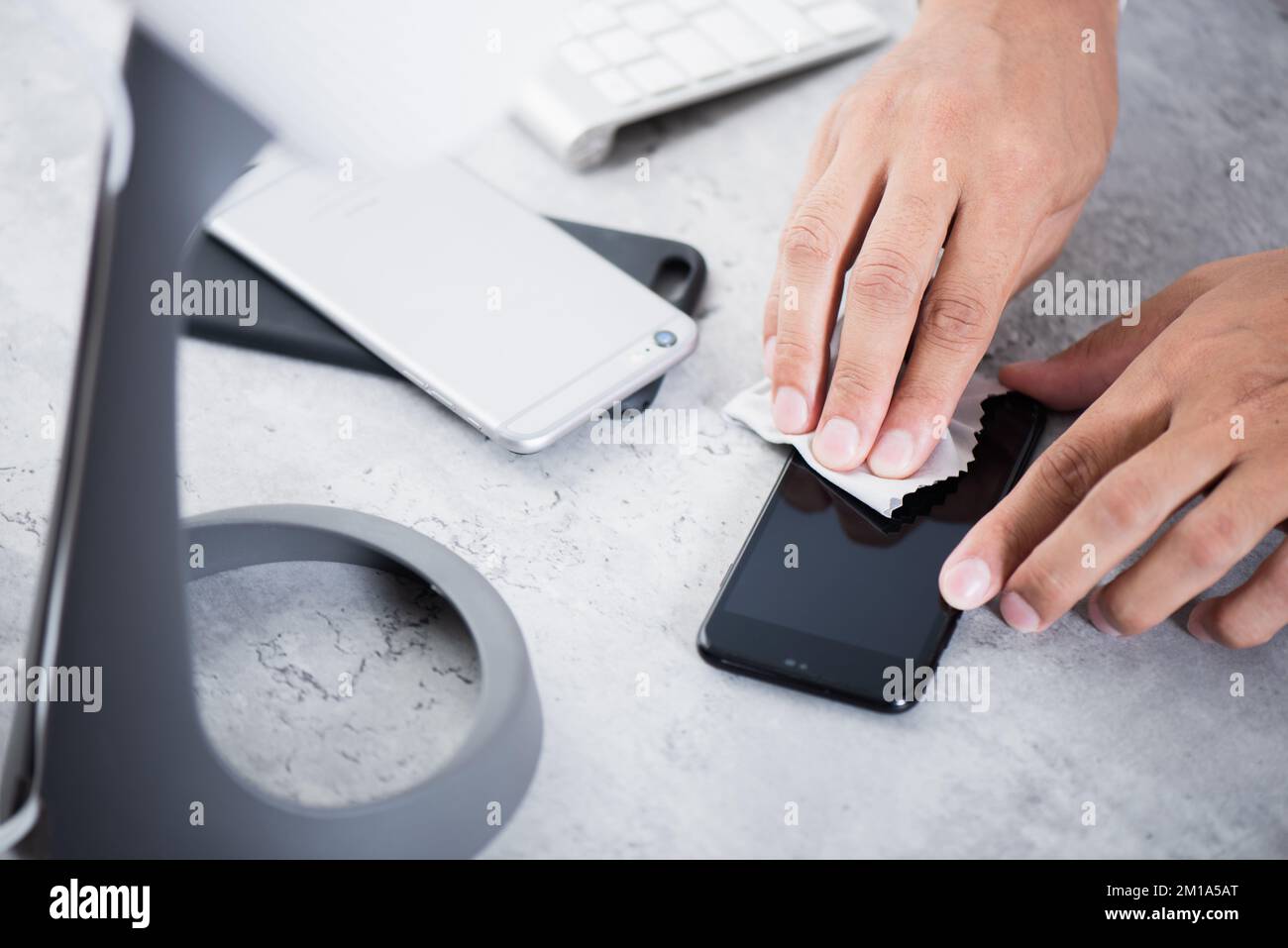 Cleaning the smartphone with soft cloth and alcohol. COVID-19 ...