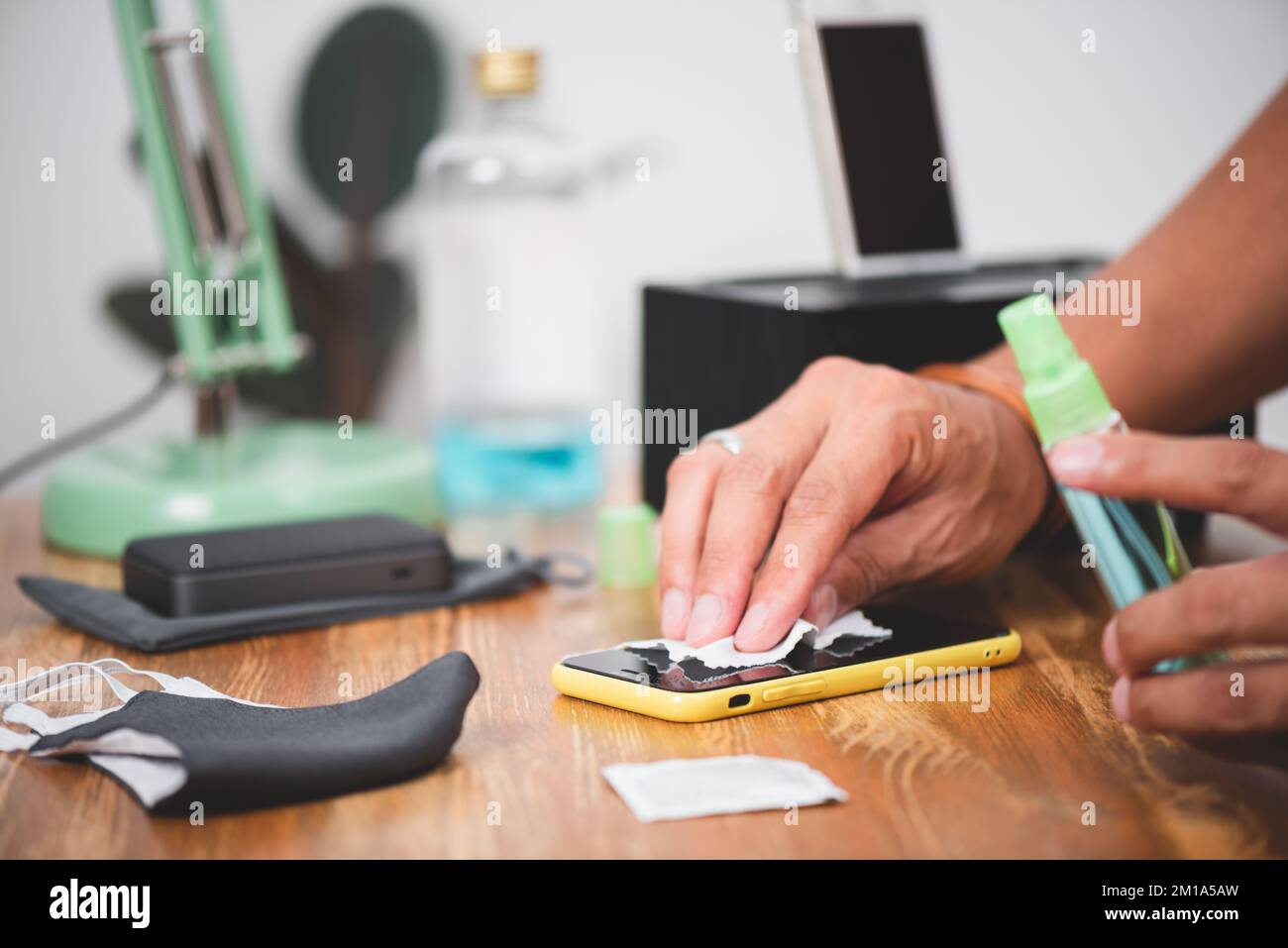 Cleaning the smartphone with soft cloth and alcohol. COVID-19 ...
