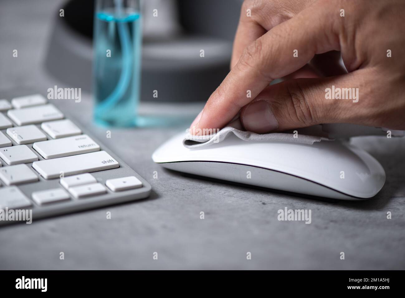 The man cleaning his computer mouse. COVID-19 prevention concept Stock ...