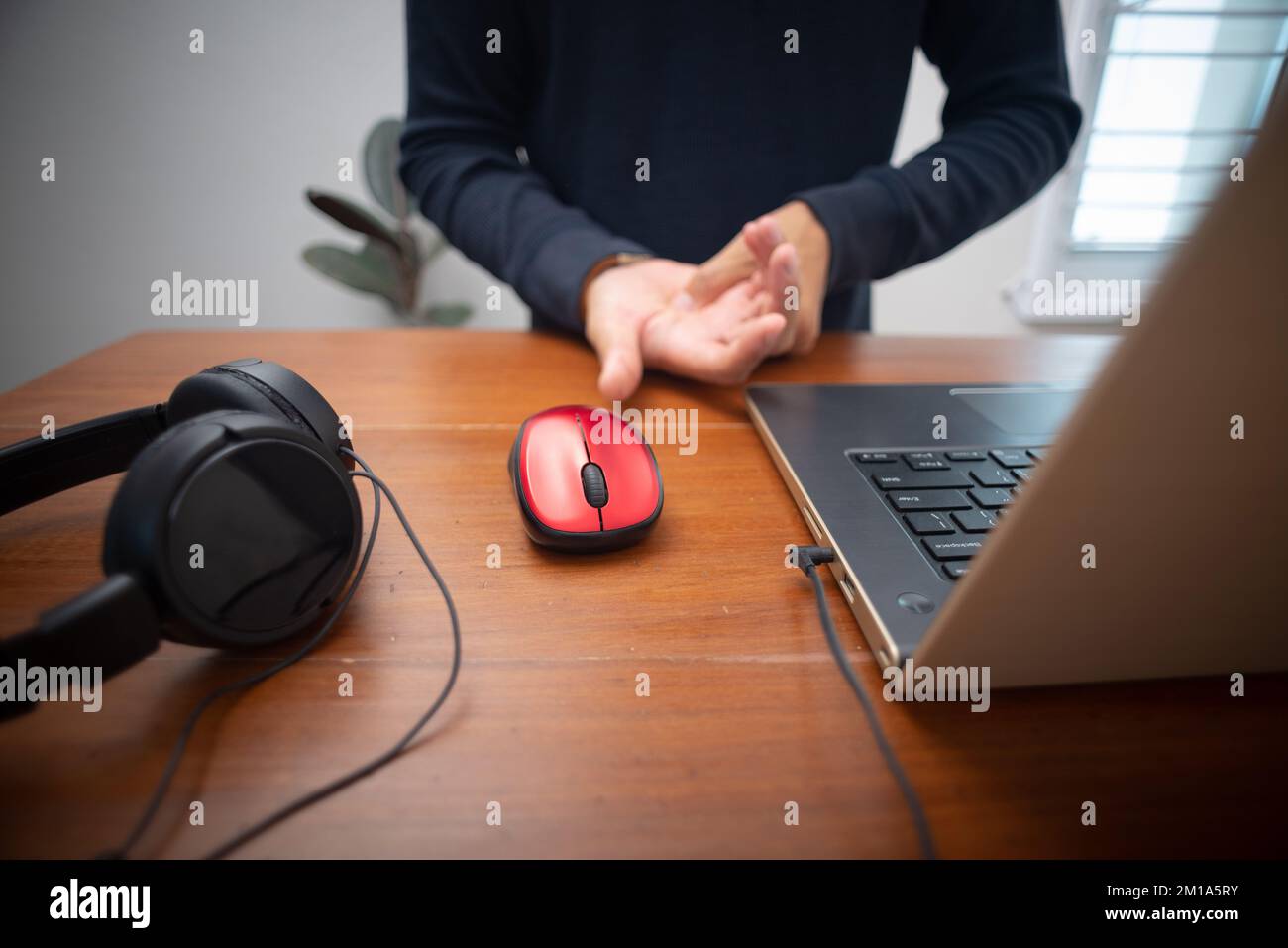 The man wrist pain after use the computer mouse Stock Photo - Alamy