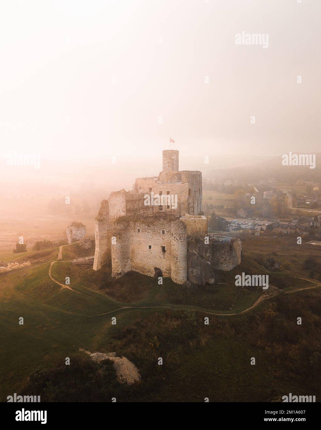 An aerial shot of the Mirow Castle ruins in Mirow, Poland, in foggy ...
