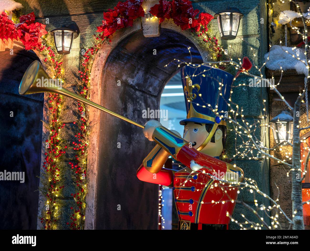 Big nutcracker playing music on trumpet outdoor. Christmas toy on ...