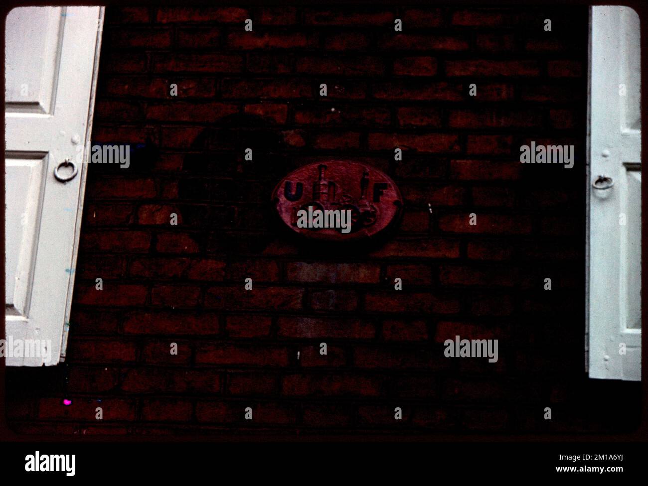 'UF' fire insurance mark on brick wall , Plaques. Edmund L. Mitchell ...