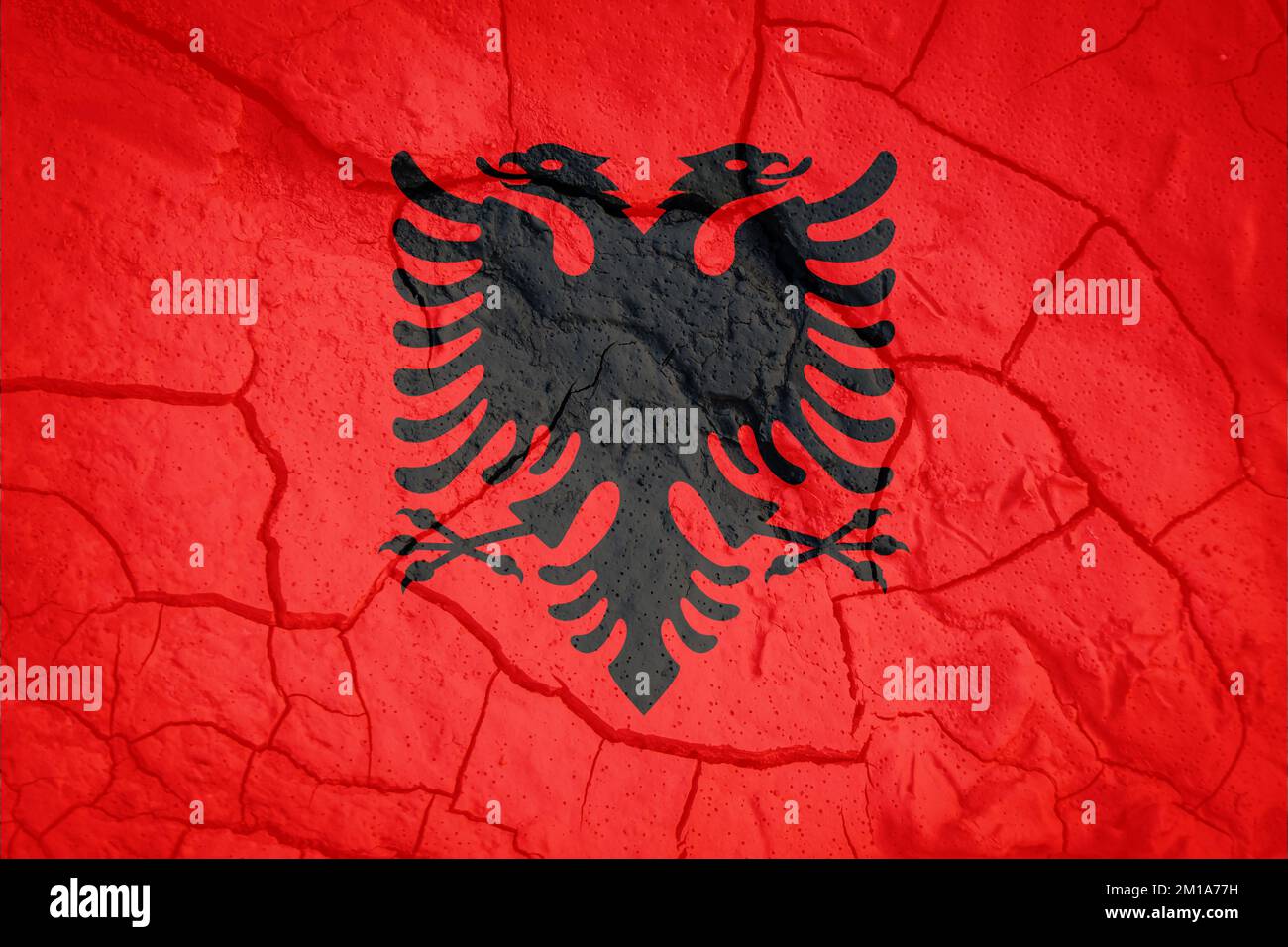 Flag of Albania. Albanian symbol. Flag on the background of dry cracked earth. Albanian flag ...