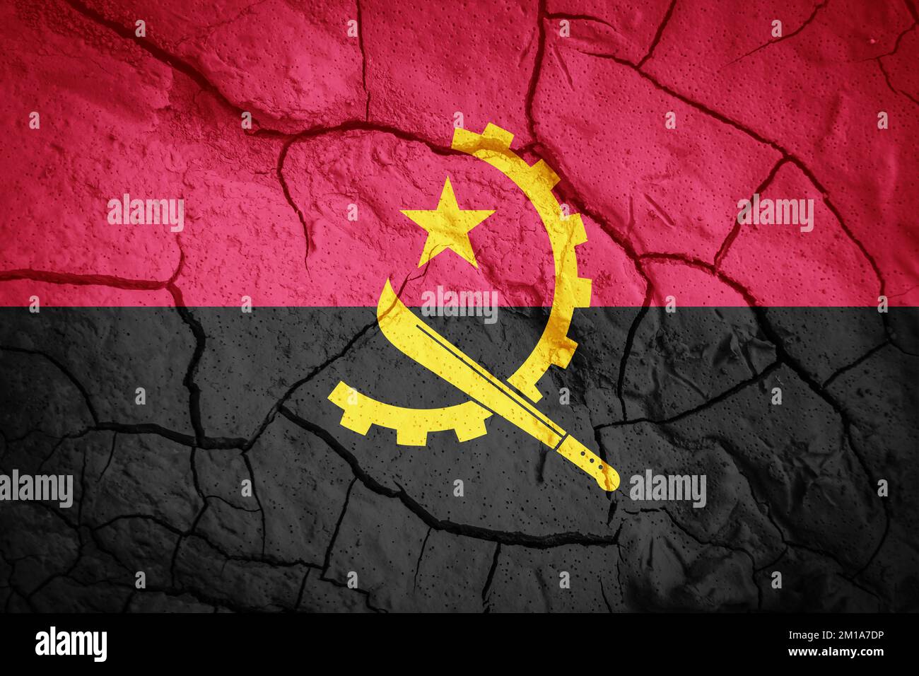 Flag of Angola. Angolan symbol. Flag on the background of dry cracked ...