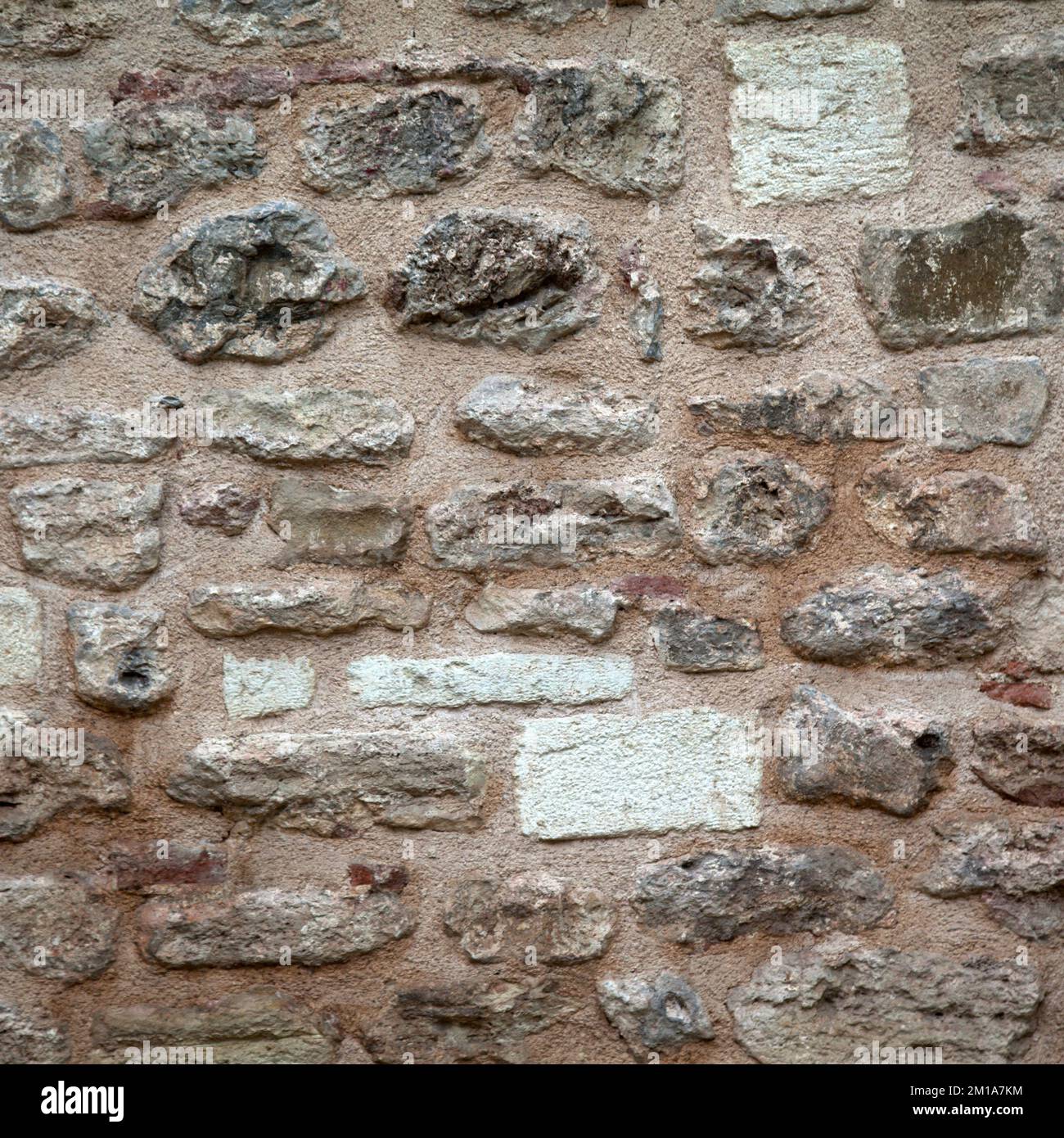 Sturdy beige and purple cut stone wall, good for backgrounds, seamless ...