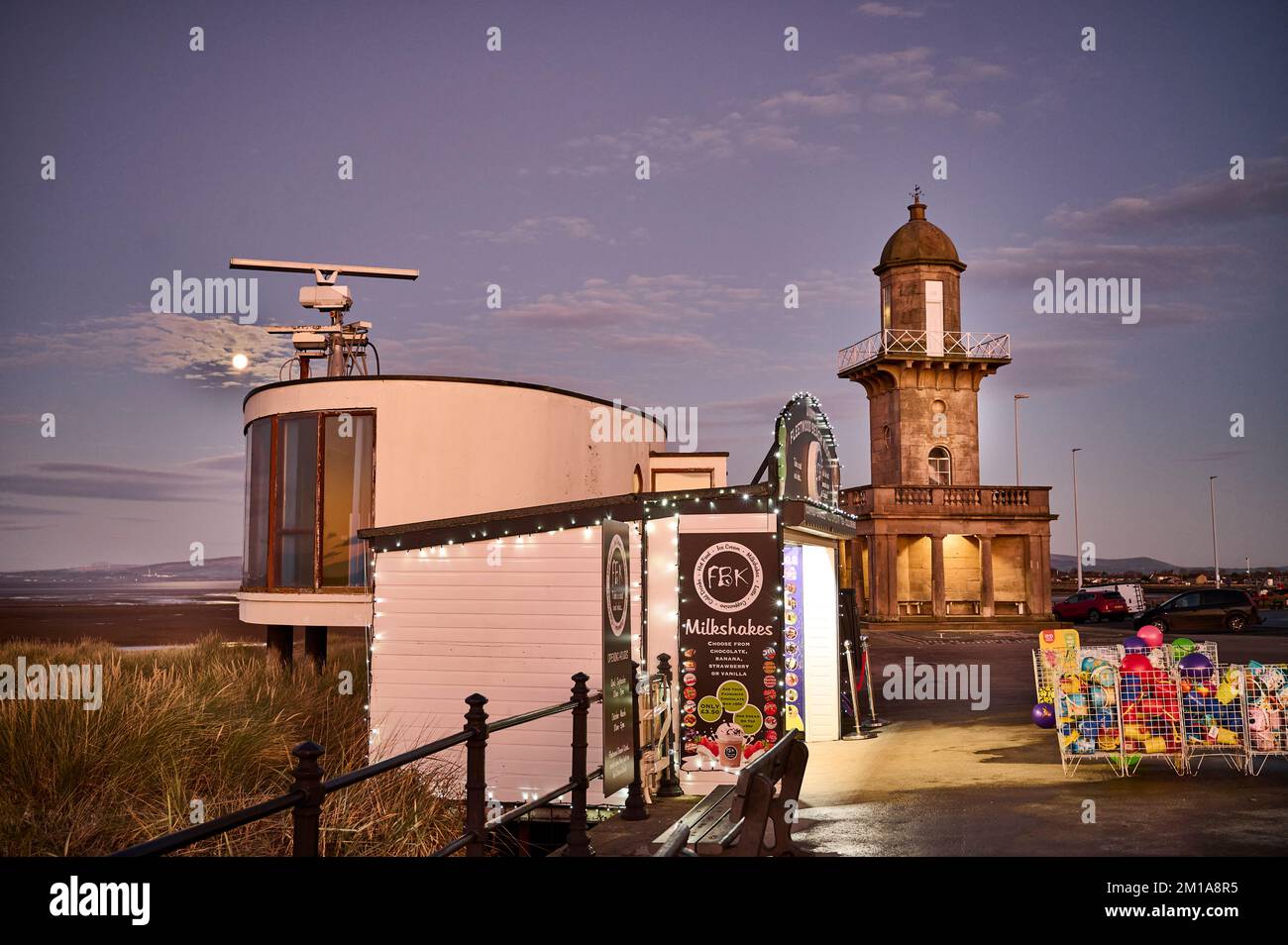 Fleetwood beach kiosk, radar station and lighthouse at night under full ...
