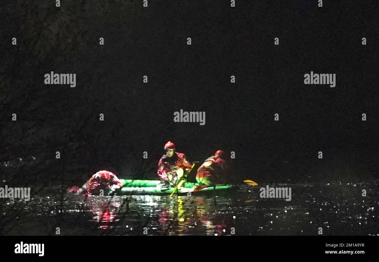 Emergency personnel search the lake at the scene in Babbs Mill Park in ...