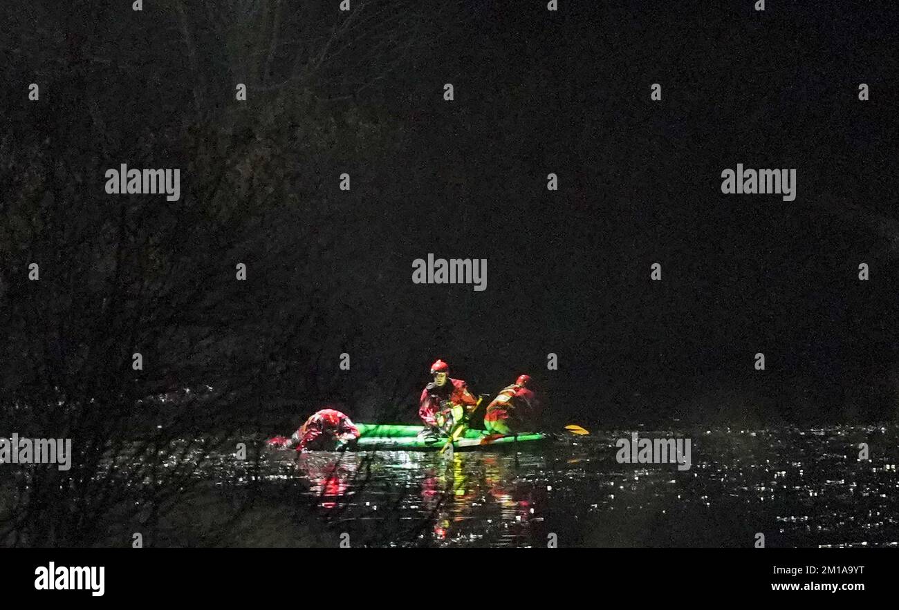 Emergency personnel search the lake at the scene in Babbs Mill Park in ...