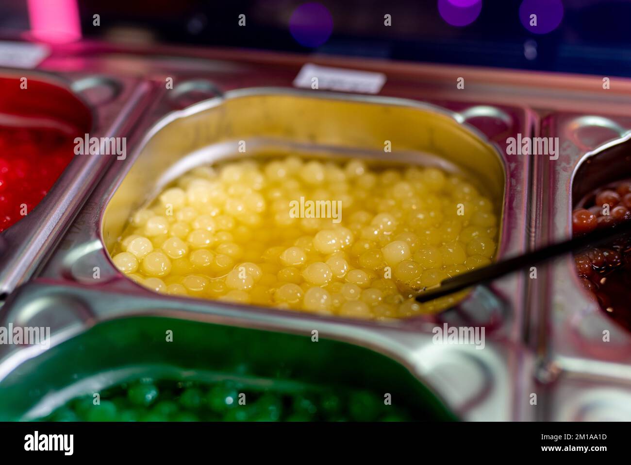A selective focus of colorful yellow roe Caviar food displayed on metal ...