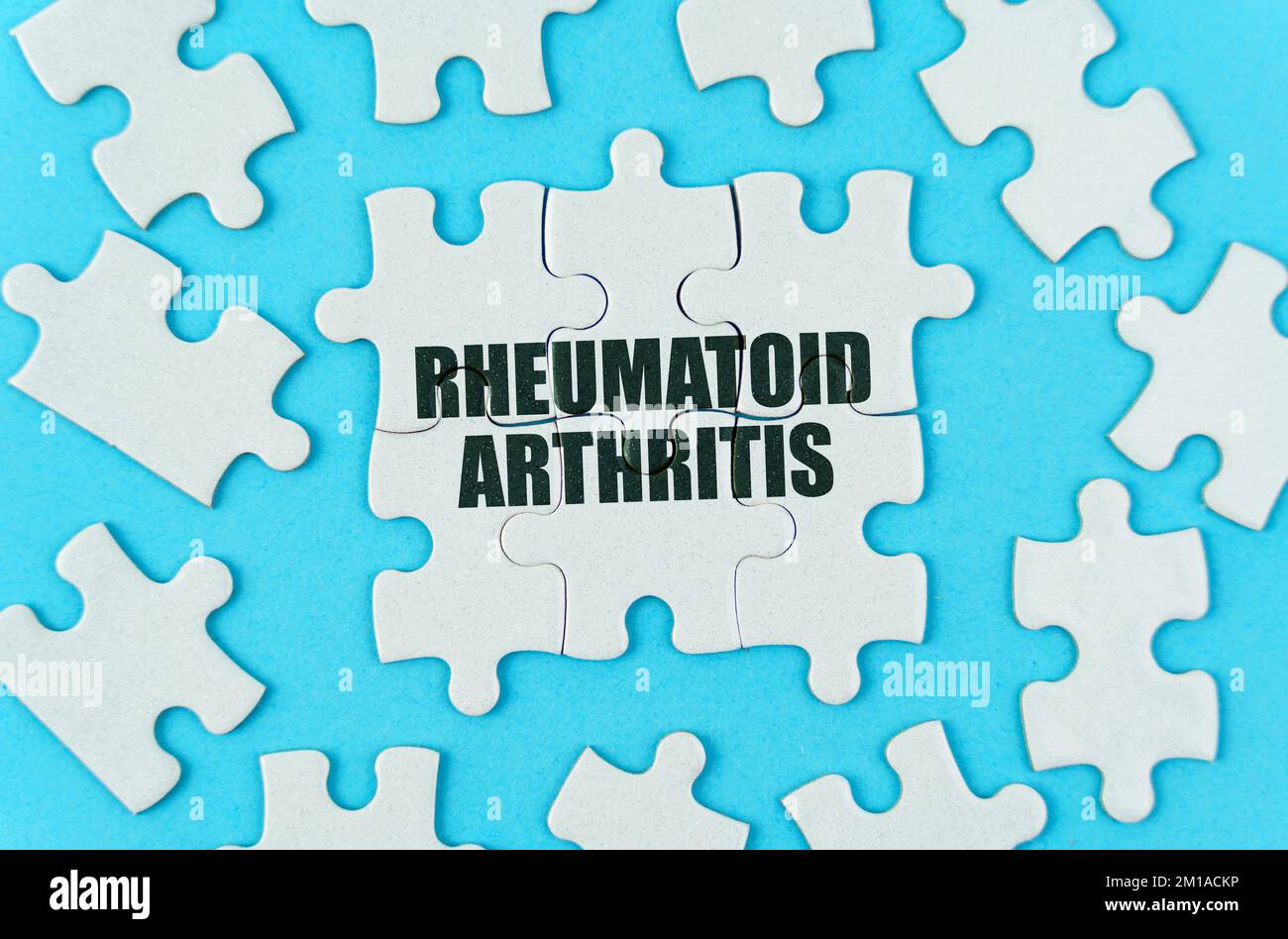 Medical concept. On a blue background are white puzzles with the ...