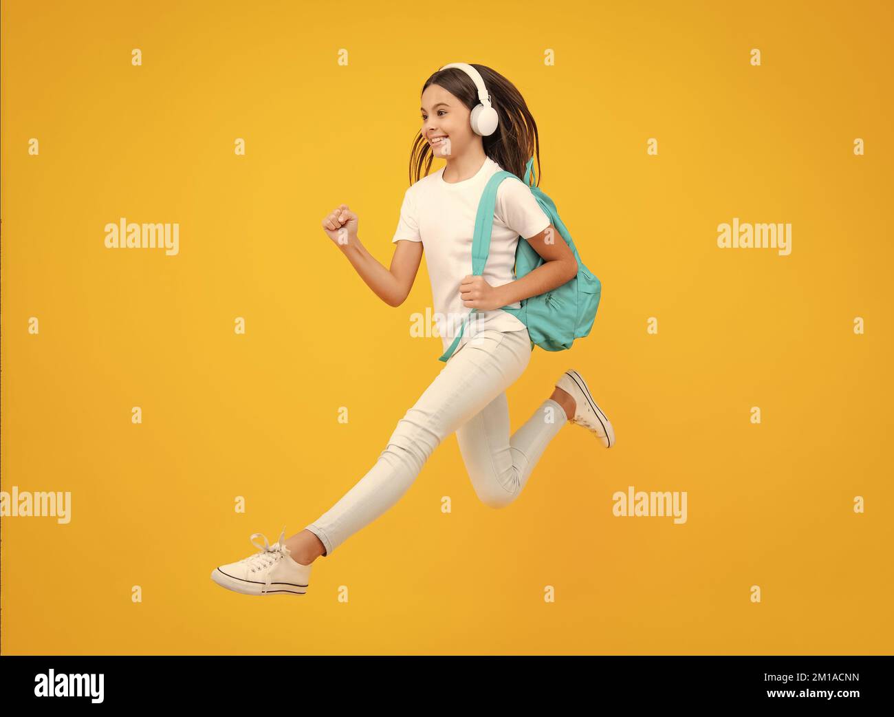 Happy teenager portrait. School teenager child girl in headphones with ...