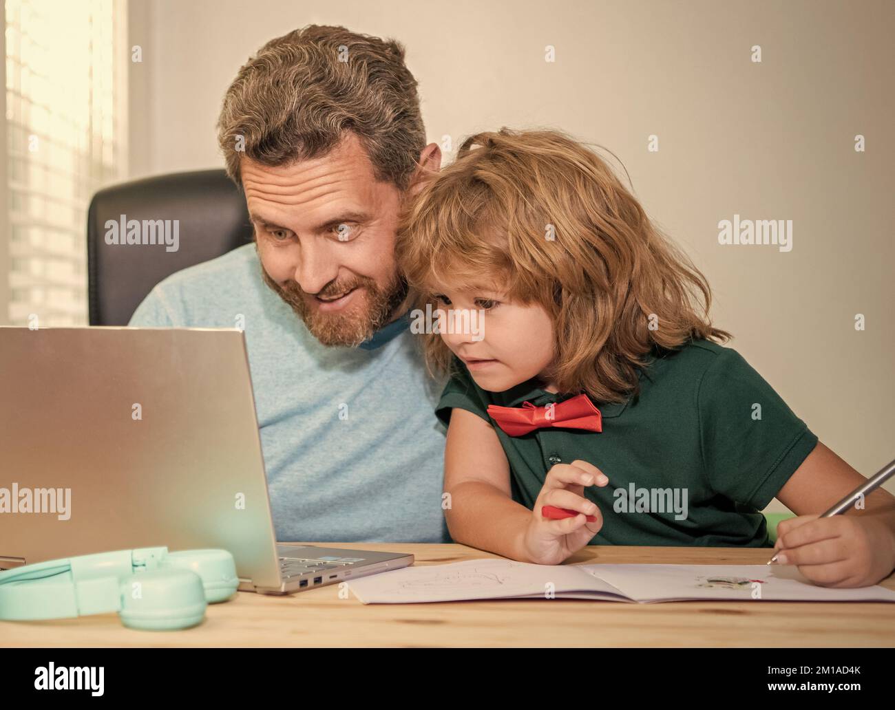 mature man teacher or dad helping kid son with school homework on ...