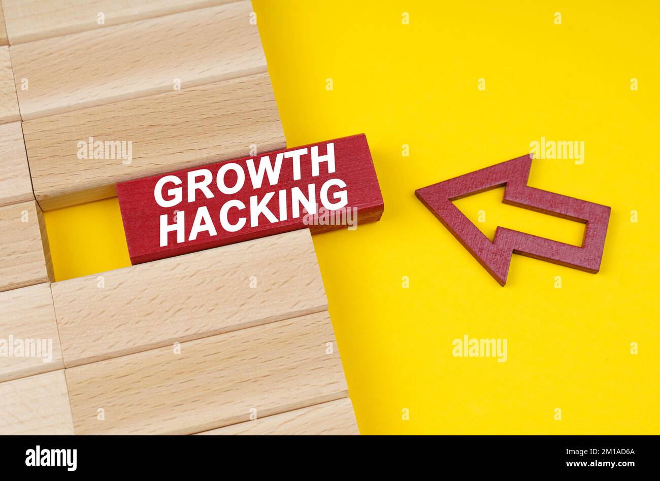 Business concept. On a yellow surface are wooden blocks and an arrow ...