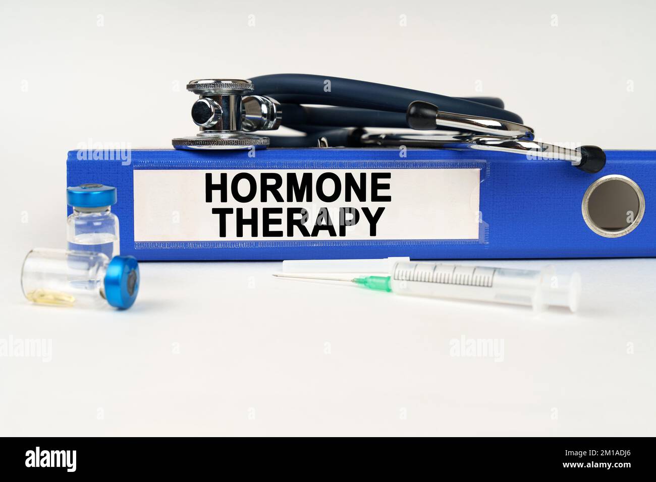 Medical concept. On a white surface, a syringe, a stethoscope and a ...