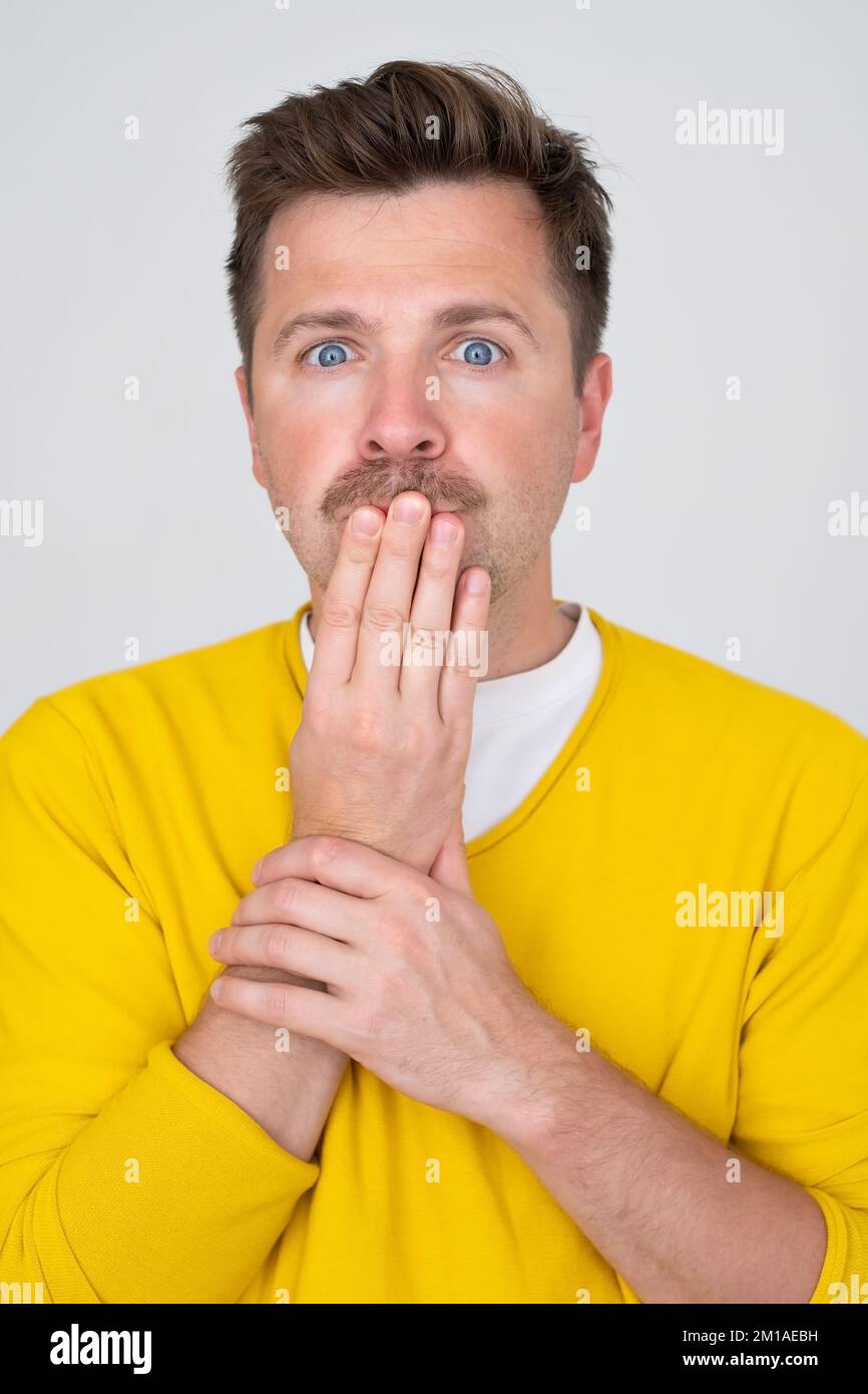 Surprised and Shocked caucasian man covering mouth with hands Stock Photo - Alamy